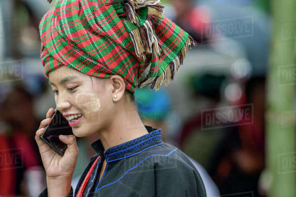 Modern Burmese young woman on smart phone; Yawngshwe, Shan State ...
