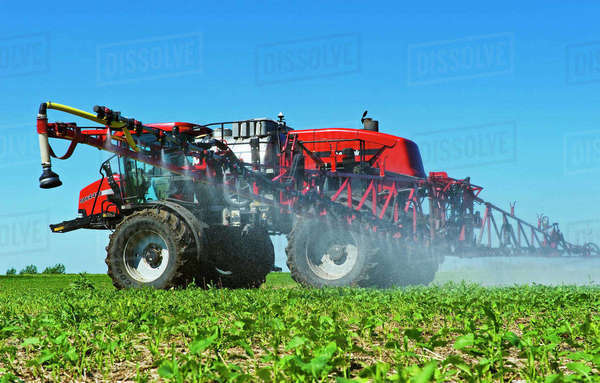 Agriculture - A high clearance Case IH sprayer applies herbicide to a ...