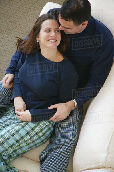 Couple Snuggles On Sofa - Royalty-free Stock Photo | Dissolve