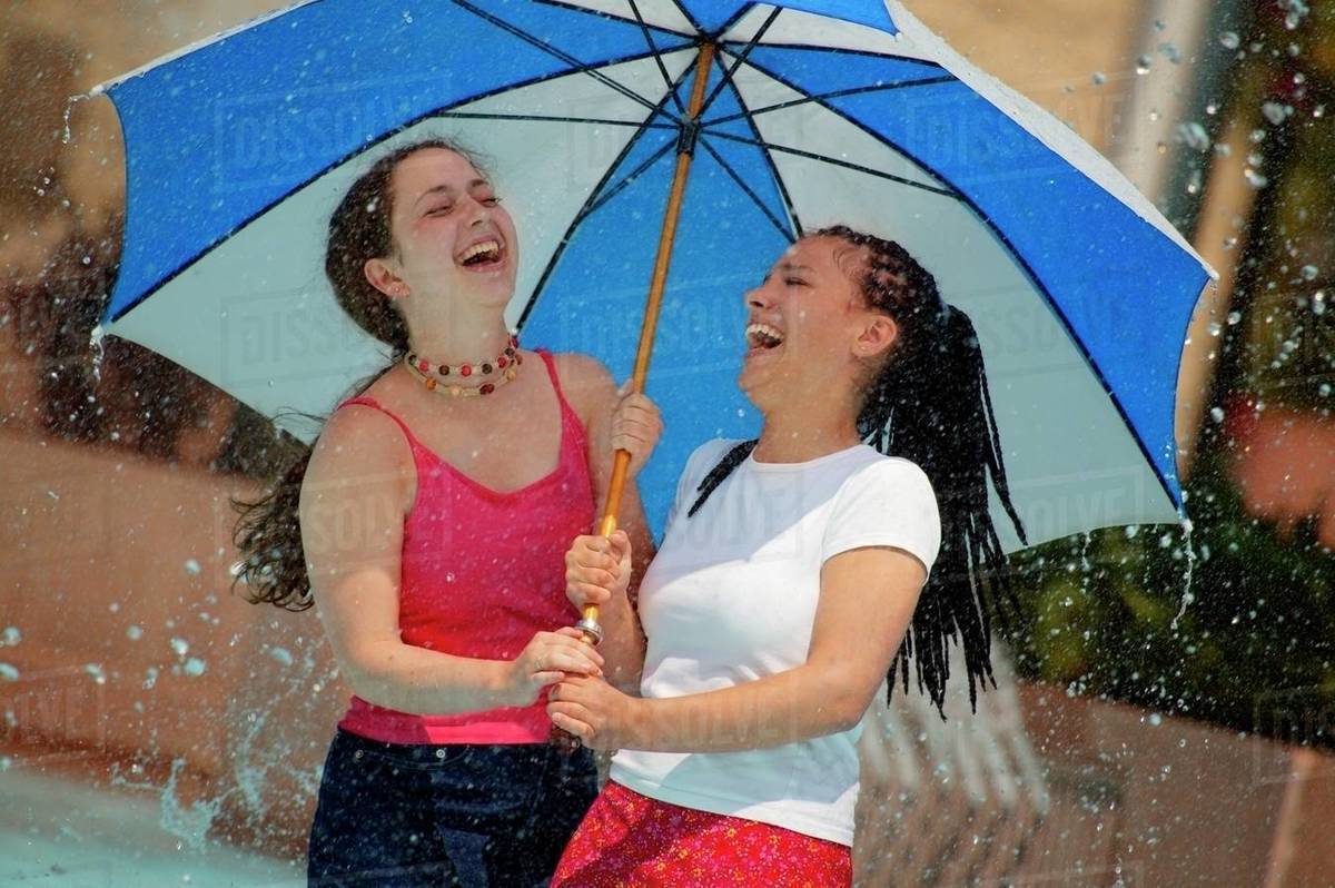 Two Friends Under Umbrella - Royalty-free Stock Photo | Dissolve