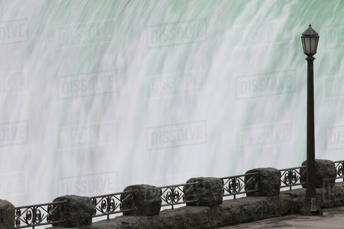 Railing and lamp post with the Horseshoe Falls in the background at ...
