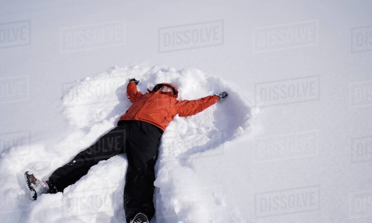 A Person Making A Snow Angel - Stock Photo - Dissolve
