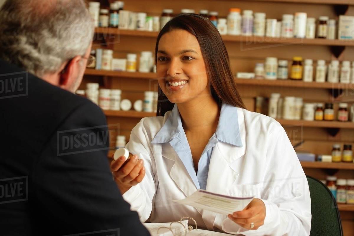 A Pharmacist With A Patient - Stock Photo - Dissolve