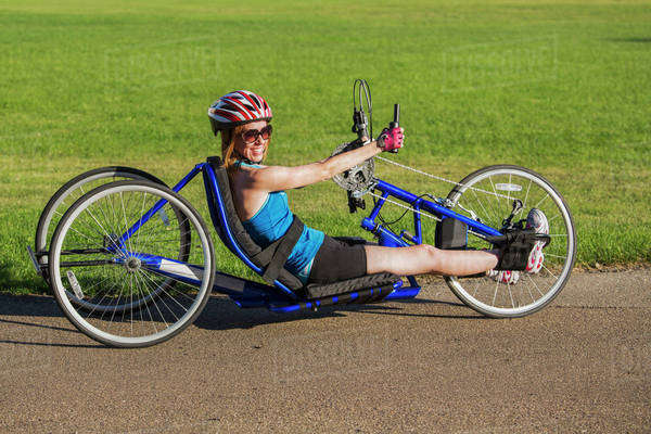 Woman with spinal cord injury cycling using hand propelled bicycle ...