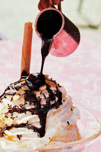 Pouring chocolate over a dessert; Bernese Oberland, Switzerland ...