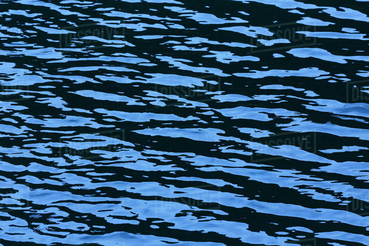 Ripples of water on a lake; Italy - Stock Photo - Dissolve