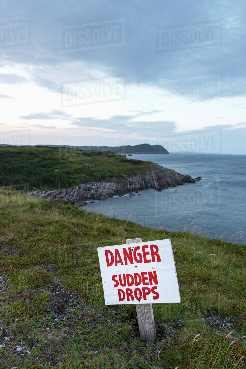 A sign warning a danger and sudden drops along the atlantic coastline ...