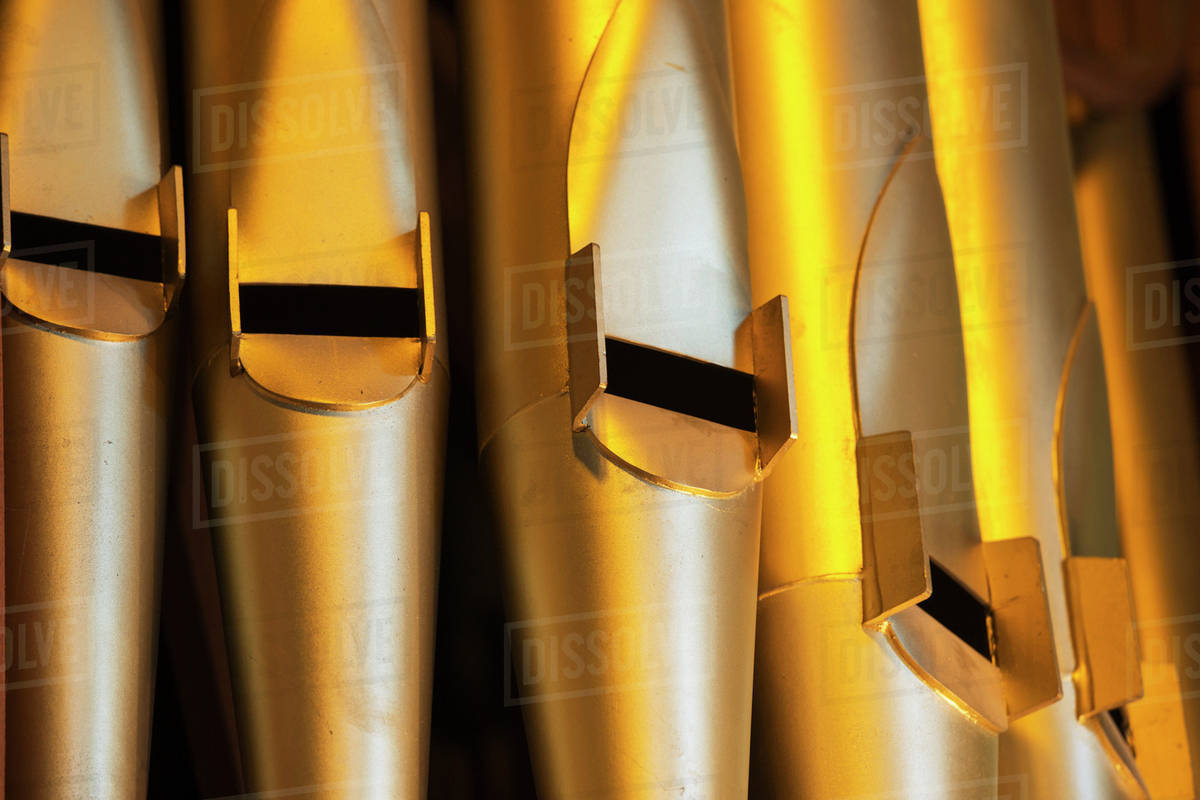 Close up of the gold pipes of a pipe organ; Northumberland, England ...