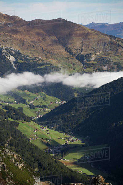 View from a mountain top looking down a green meadow valley with some ...