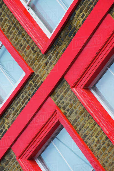 Bright red trim around windows on a brick building; London, England ...