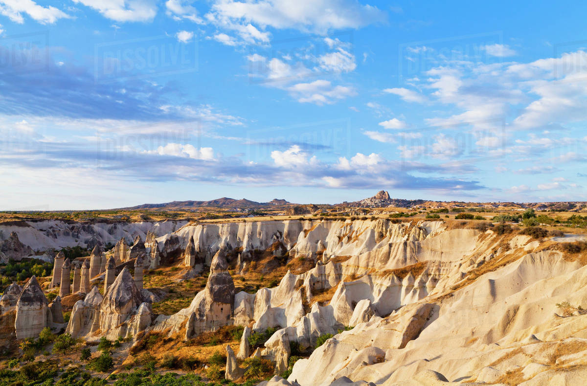 Fairy chimneys in the rugged, barren landscape of Honey Valley ...