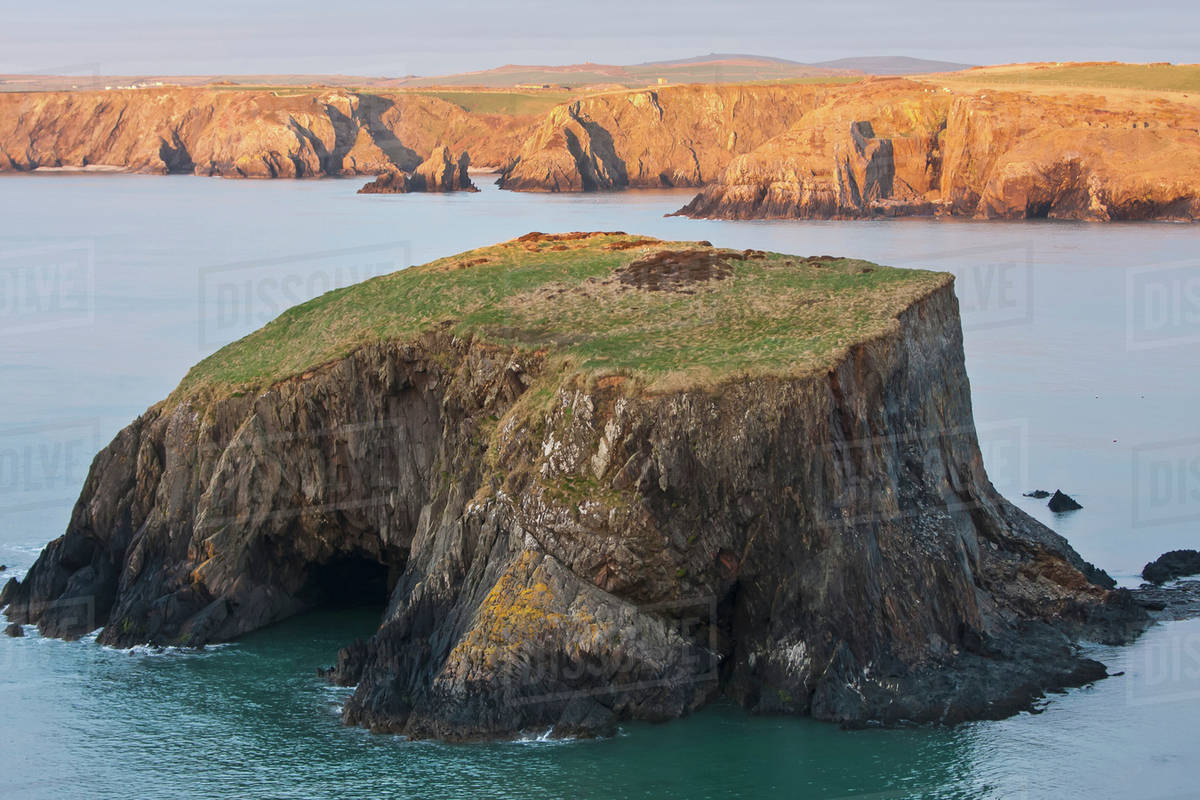 Small island and cliffs at sundown near Trefin village on the ...