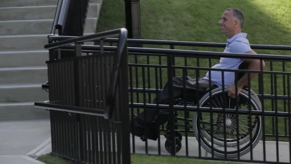 Man with spinal cord injury in a wheelchair using accessible wheelchair ...