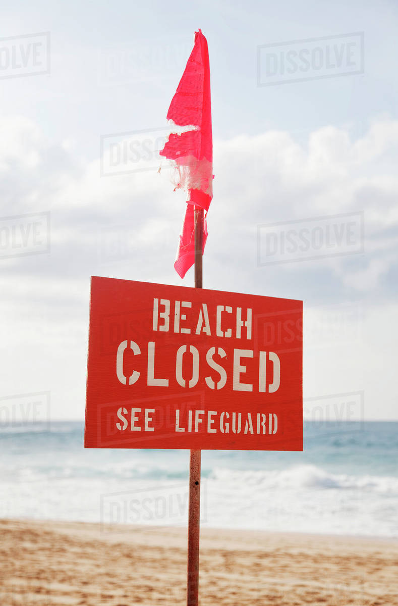 Beach closed sign on the shore due to hazardous conditions;Honolulu ...