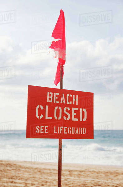 Beach closed sign on the shore due to hazardous conditions;Honolulu ...