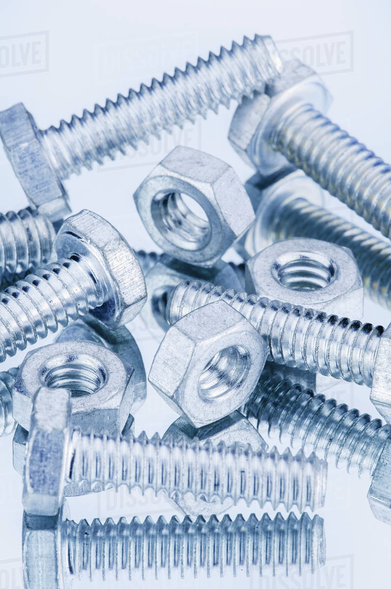 Silver screws and bolts on a white background - Stock Photo - Dissolve