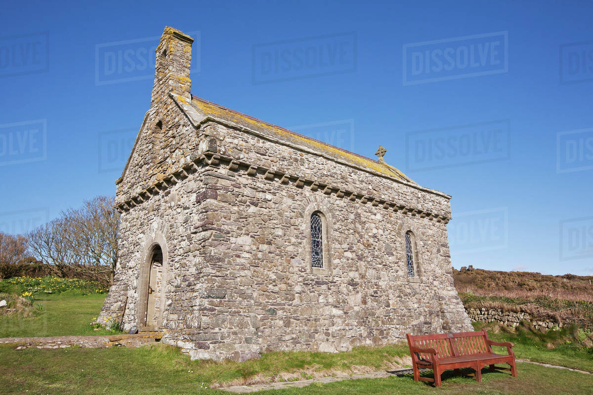 An old stone church with a bench and blue sky - Royalty-free Stock ...