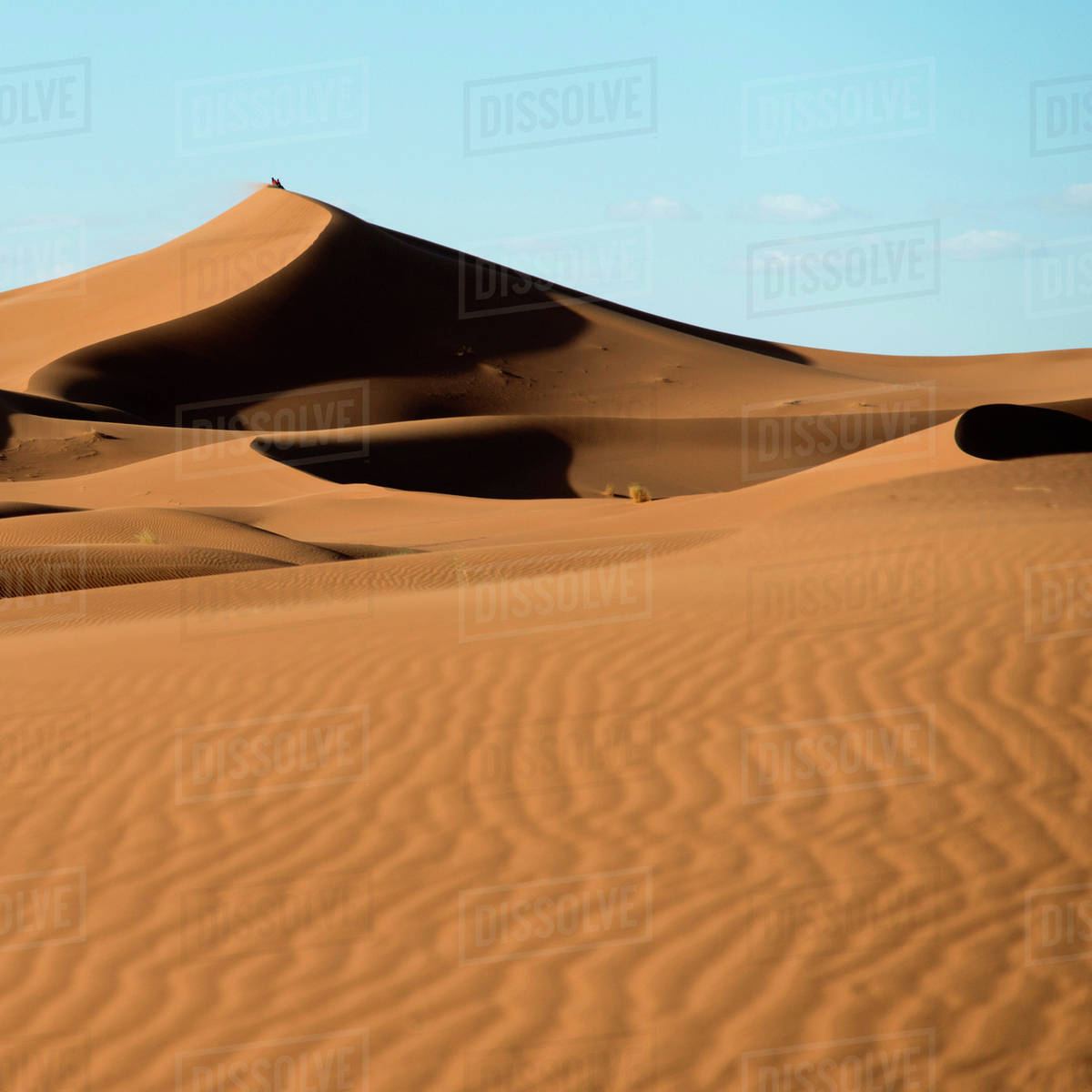 Landscape of drifted sand slopes against a blue sky - Stock Photo ...