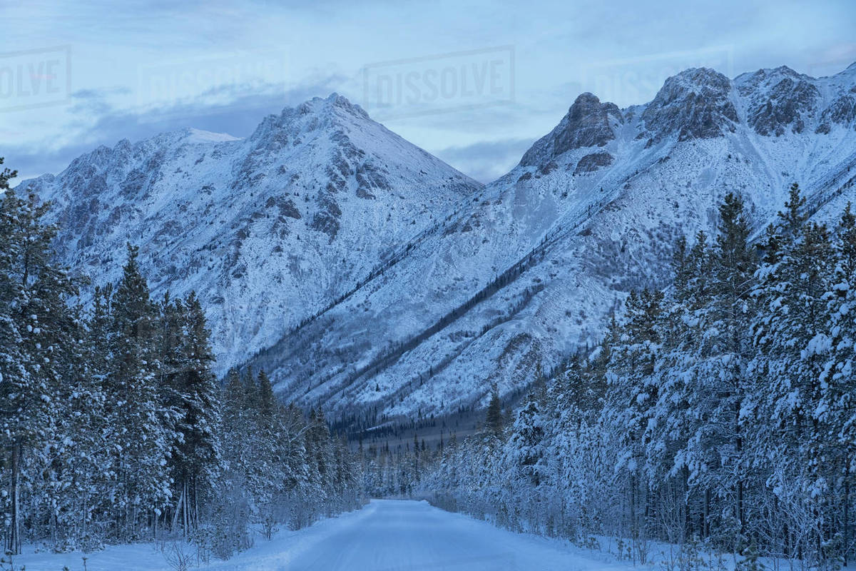 Winter landscapes of majestic mountains along the tree-lined Annie Lake ...