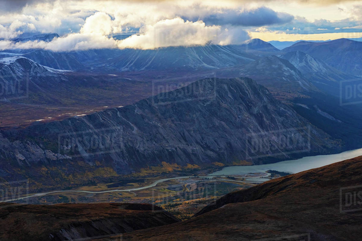 Aerial photos of a river flowing bu a cliff face of the mountains ...