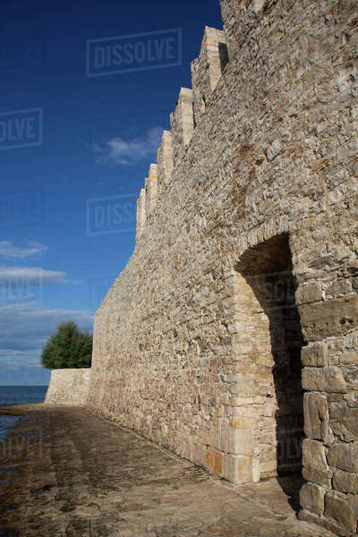 Outer city wall with doorway along the seaside in the old town of ...