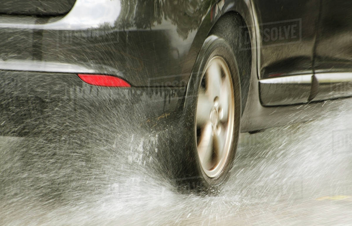 A car tire splashing through water;Locarno ticino switzerland - Royalty ...