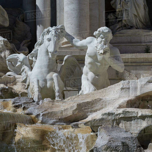 Trevi Fountain detail with a statue of man with conch and mythical ...
