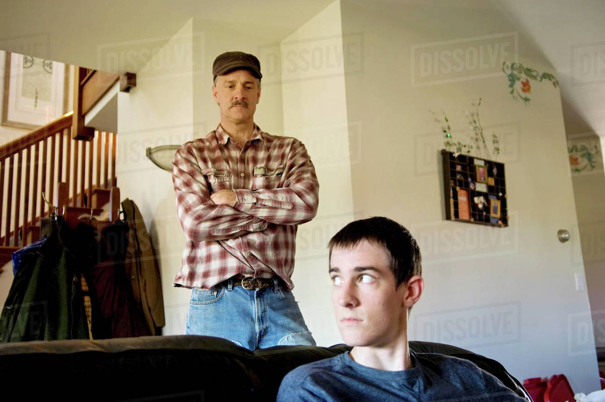 Teenage boy gets a disapproving look from his father; Lincoln, Nebraska ...