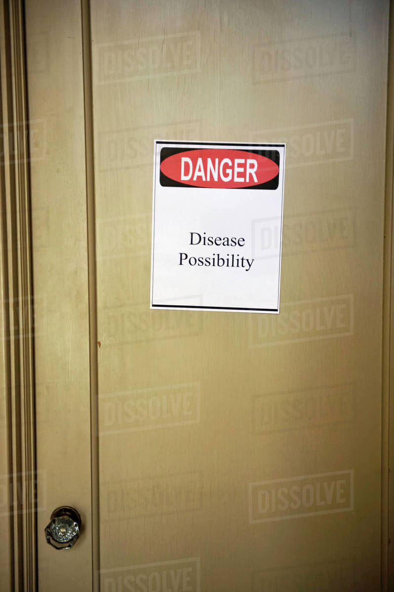 Danger sign on a closed door to prevent a risk of disease transmission ...
