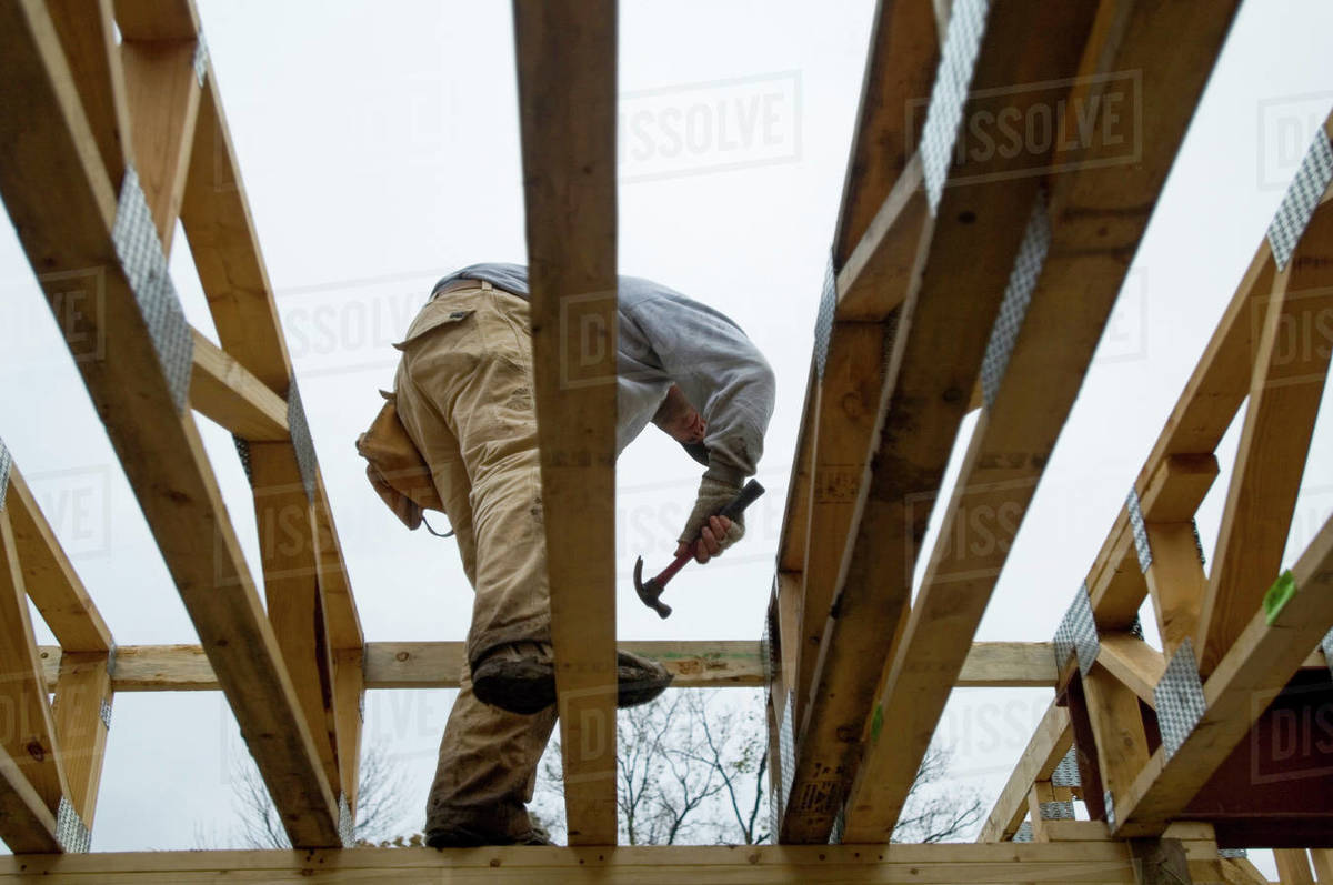 Worker framing a building on a construction site; Lincoln, Nebraska ...