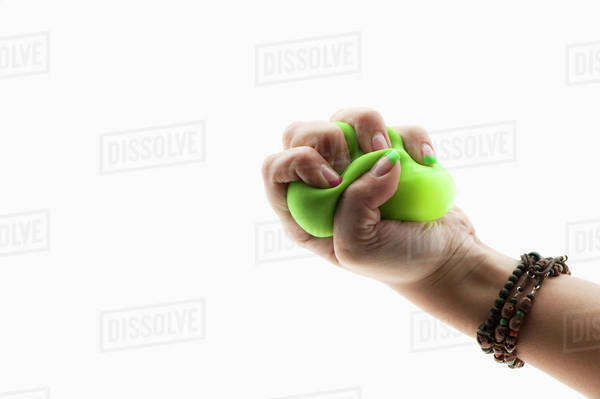 A Female Hand Squeezing A Stress Ball Against A White Background ...
