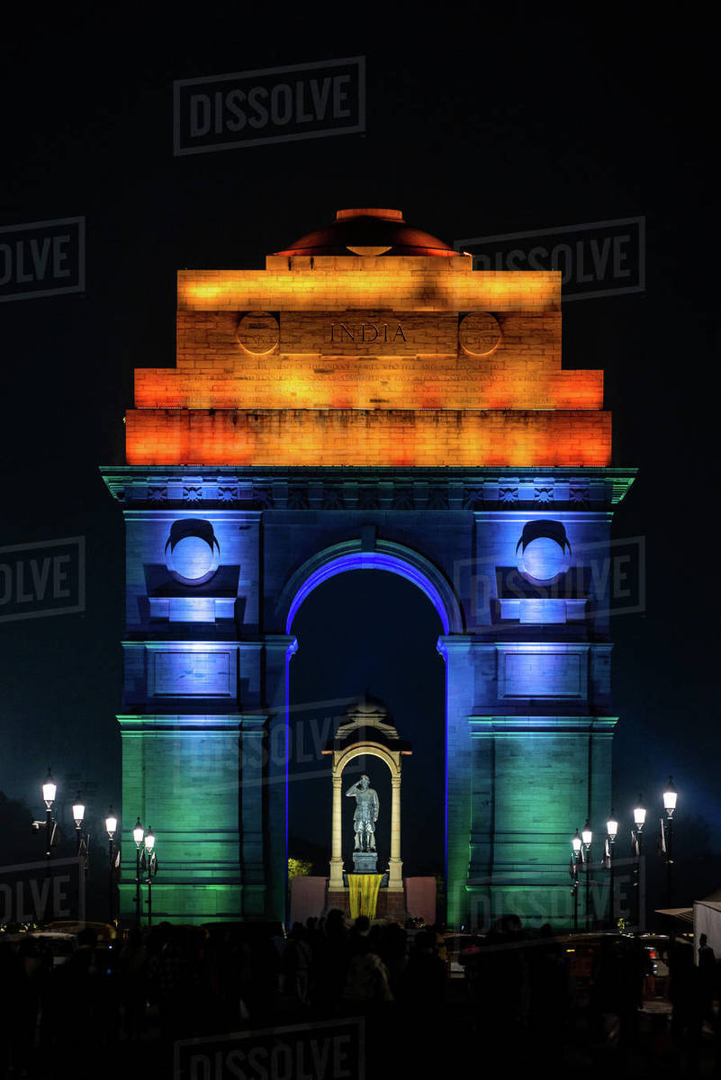India Gate illuminated in coloured lights at night; New Delhi, India ...