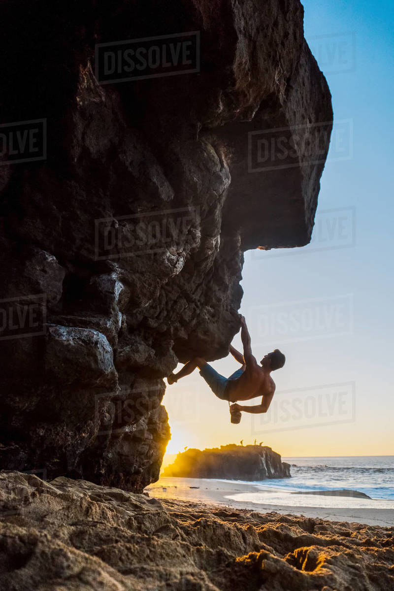 A man bouldering on the beach in Oahu. - Royalty-free Stock Photo ...