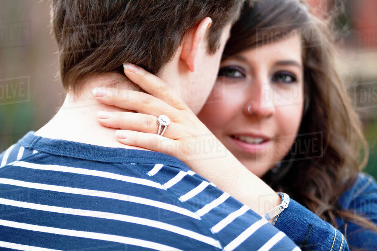 A Young Woman Wearing A Diamond Ring Embraces Her Fiance; Bellingham ...