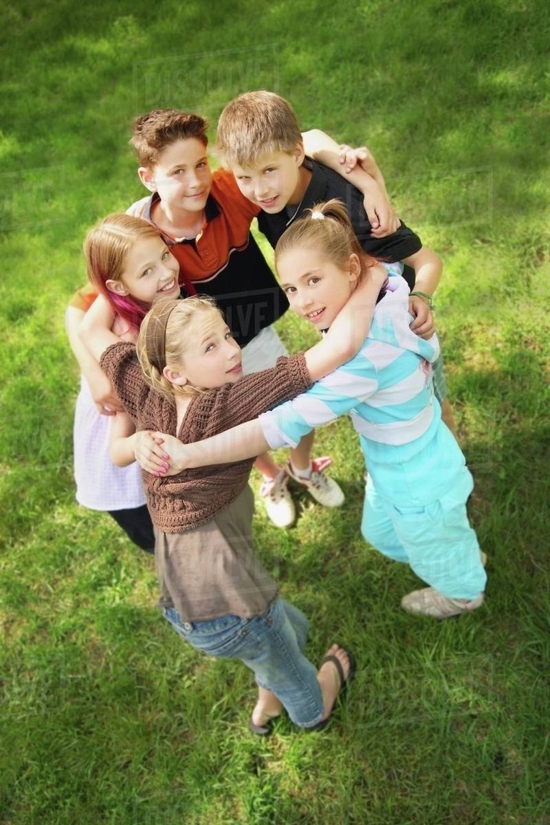 Edmonton, Alberta, Canada; A Group Of Children In A Huddle - Royalty ...