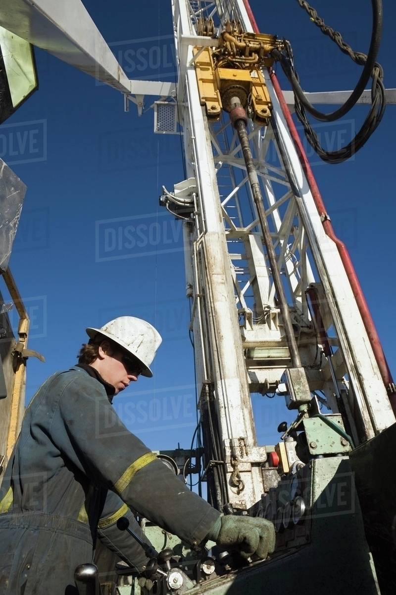 Edson, Alberta, Canada; Drilling Rig Worker Working On The Control ...
