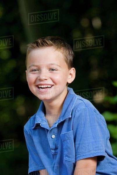 Portrait Of A Boy; Boy Smiling - Stock Photo - Dissolve