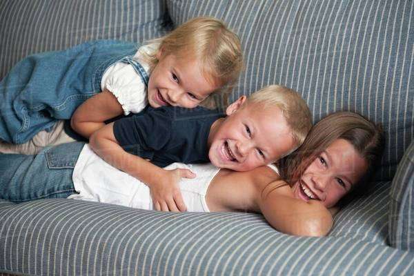 Siblings Together On Couch - Royalty-free Stock Photo | Dissolve