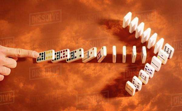 Person Knocking Over Dominoes - Royalty-free Stock Photo | Dissolve