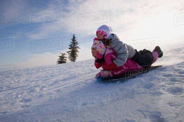 Children Tobogganing - Royalty-free Stock Photo | Dissolve