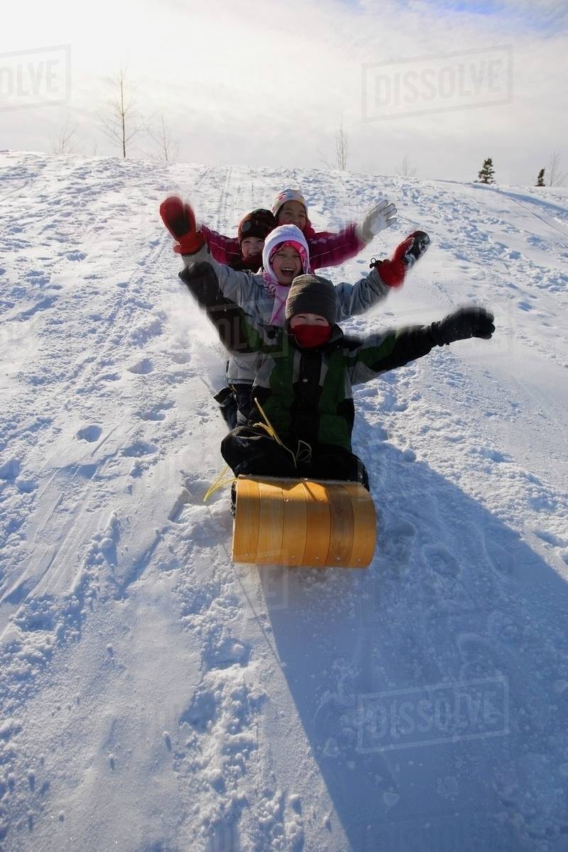 Children Tobogganing - Royalty-free Stock Photo | Dissolve
