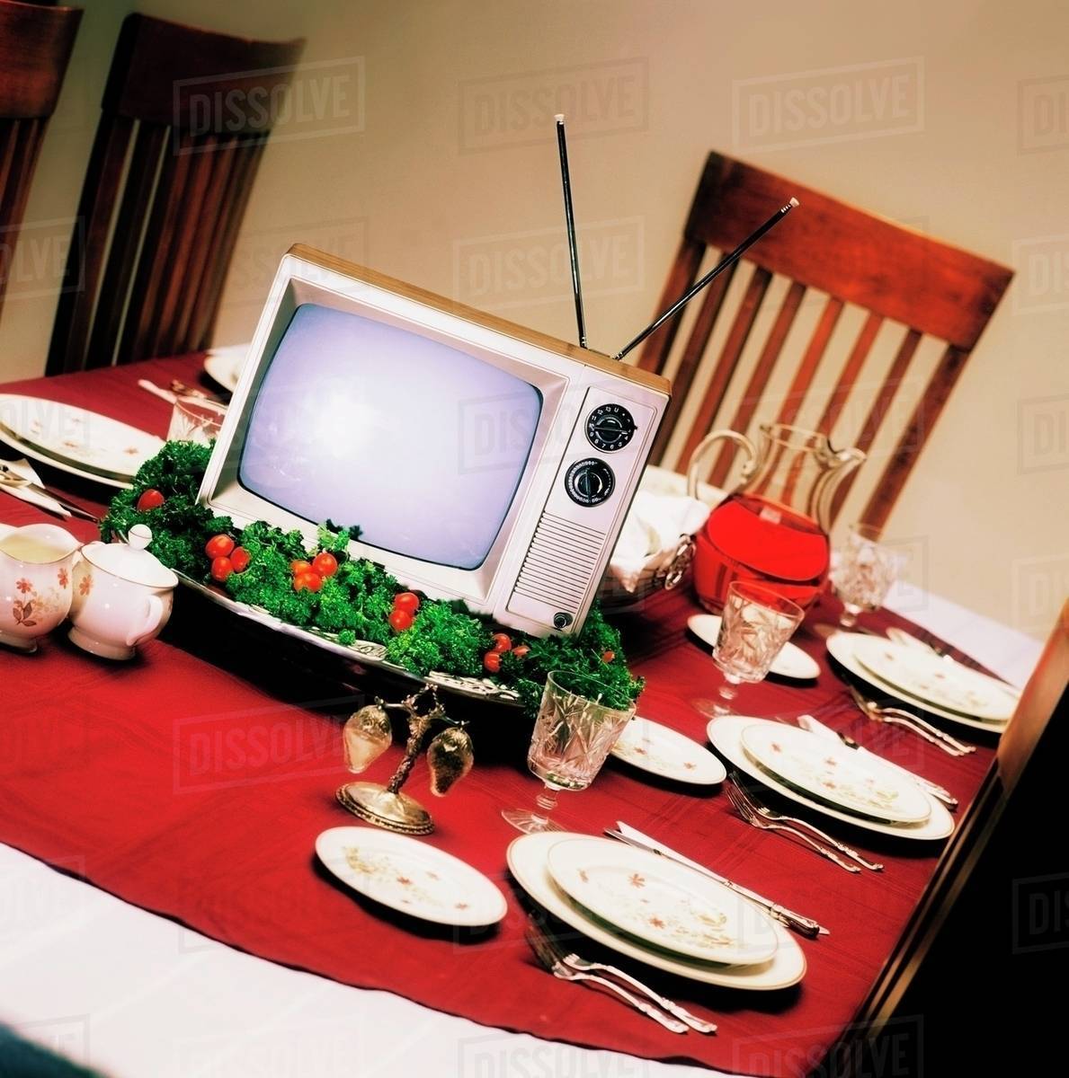 Tv In The Middle Of The Dinner Table - Royalty-free Stock Photo | Dissolve