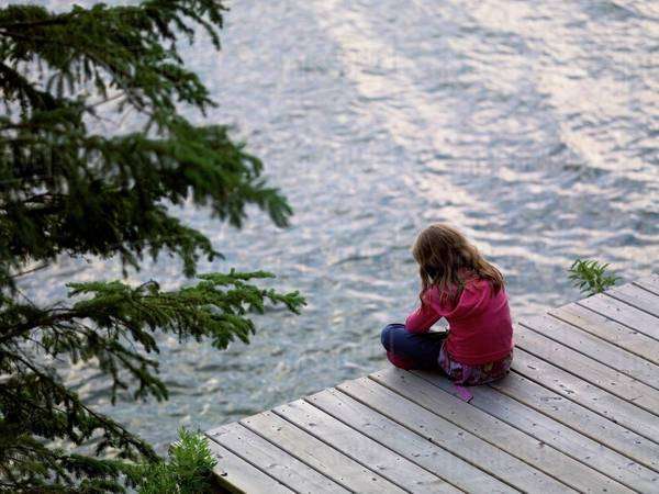 Girl Sitting On A Dock - Royalty-free Stock Photo | Dissolve