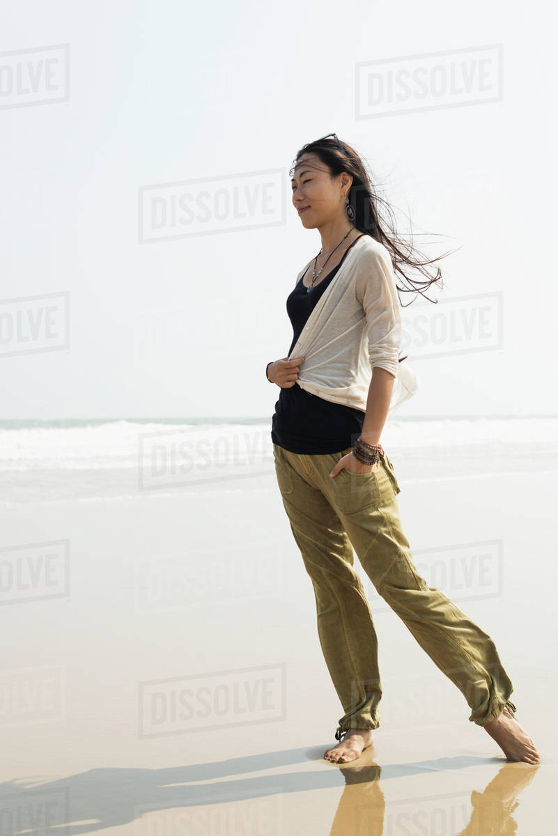 Young woman walking on the beach from HuoHu, North of Kinmen Island ...