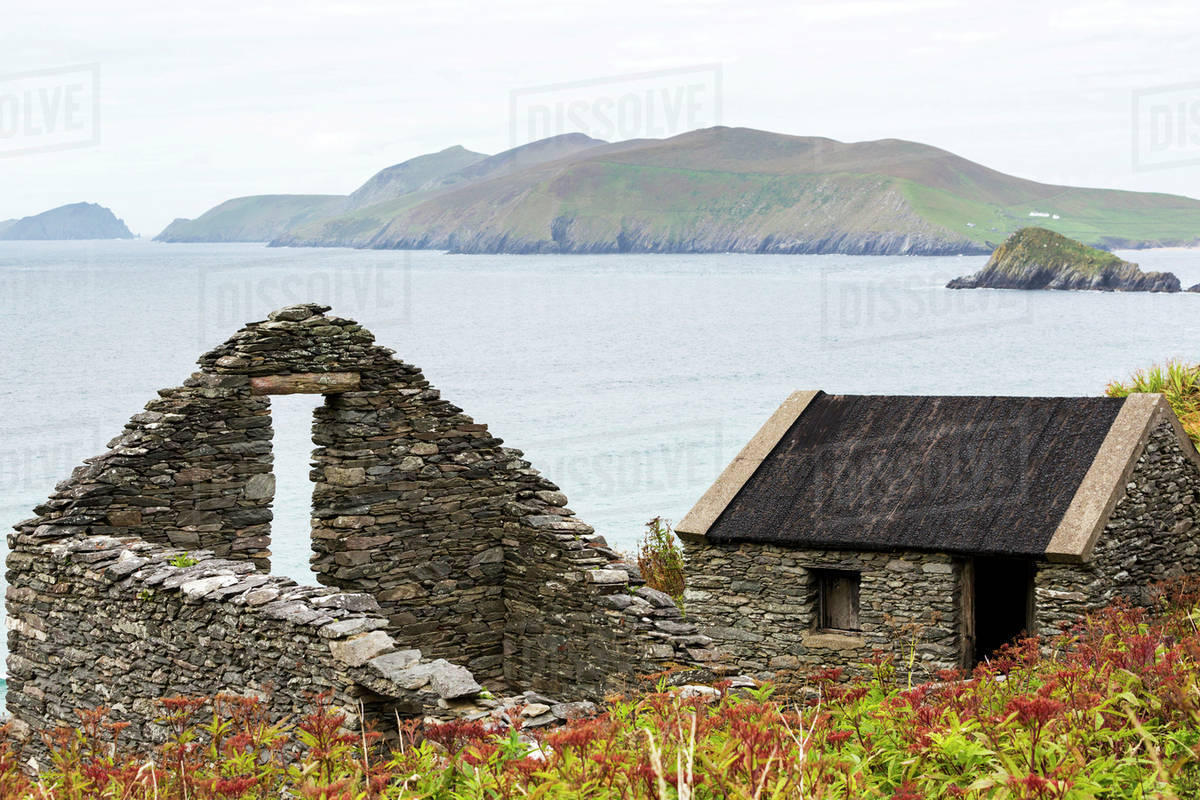 Roofless stone building and roofed stone building overlooking the bay ...