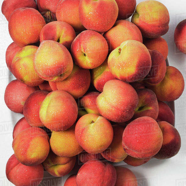 A pile of fresh peaches - Stock Photo - Dissolve