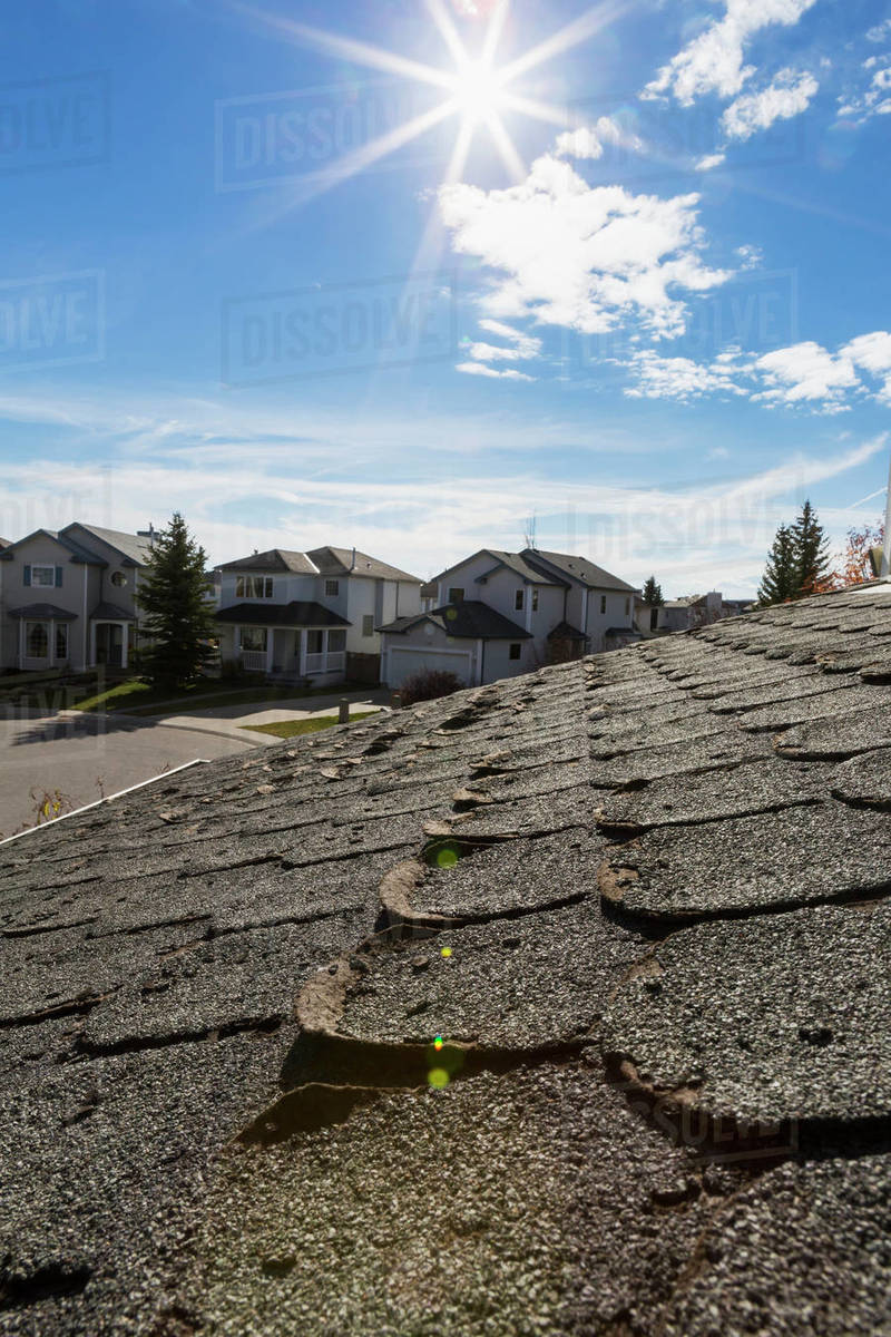 Close Up Of Well Worn Rounded Roof Shingles With Neighbourhood Houses ...