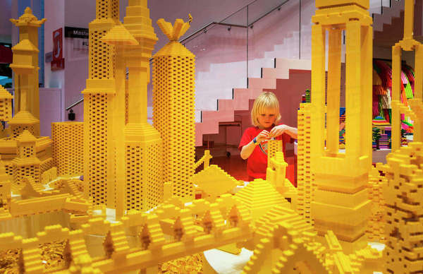 Boy building Lego tower in the Red Zone of the Lego House; Billund ...