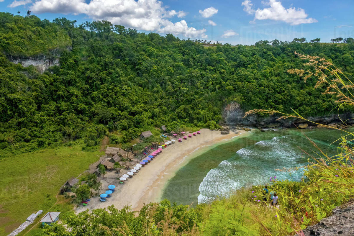 Indonesia. Tropical island. A small empty beach between rocks and ...