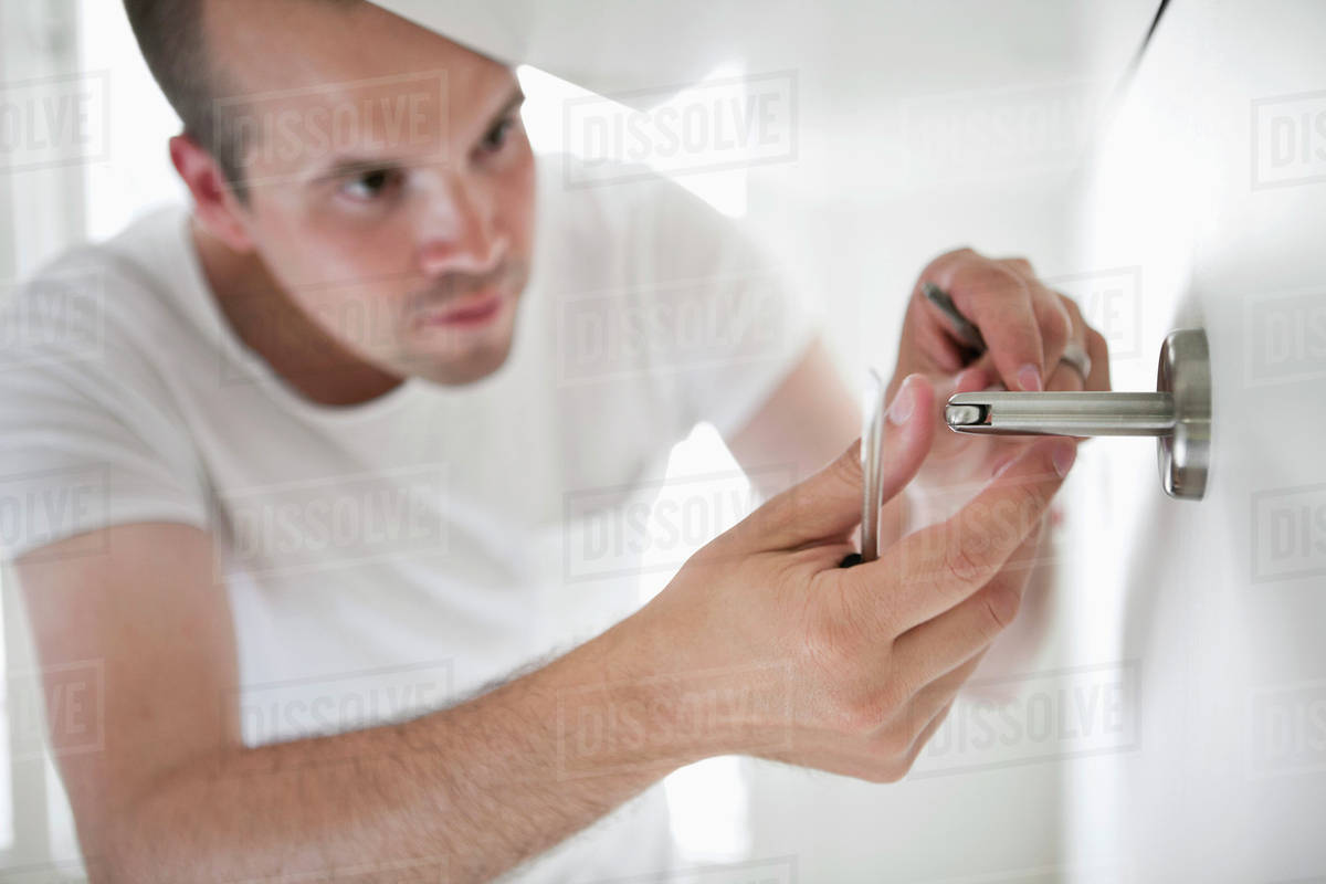 Man fixing handle - Royalty-free Stock Photo | Dissolve